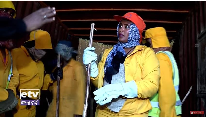 Artist Tigist Girma cleaning the road to teach the community